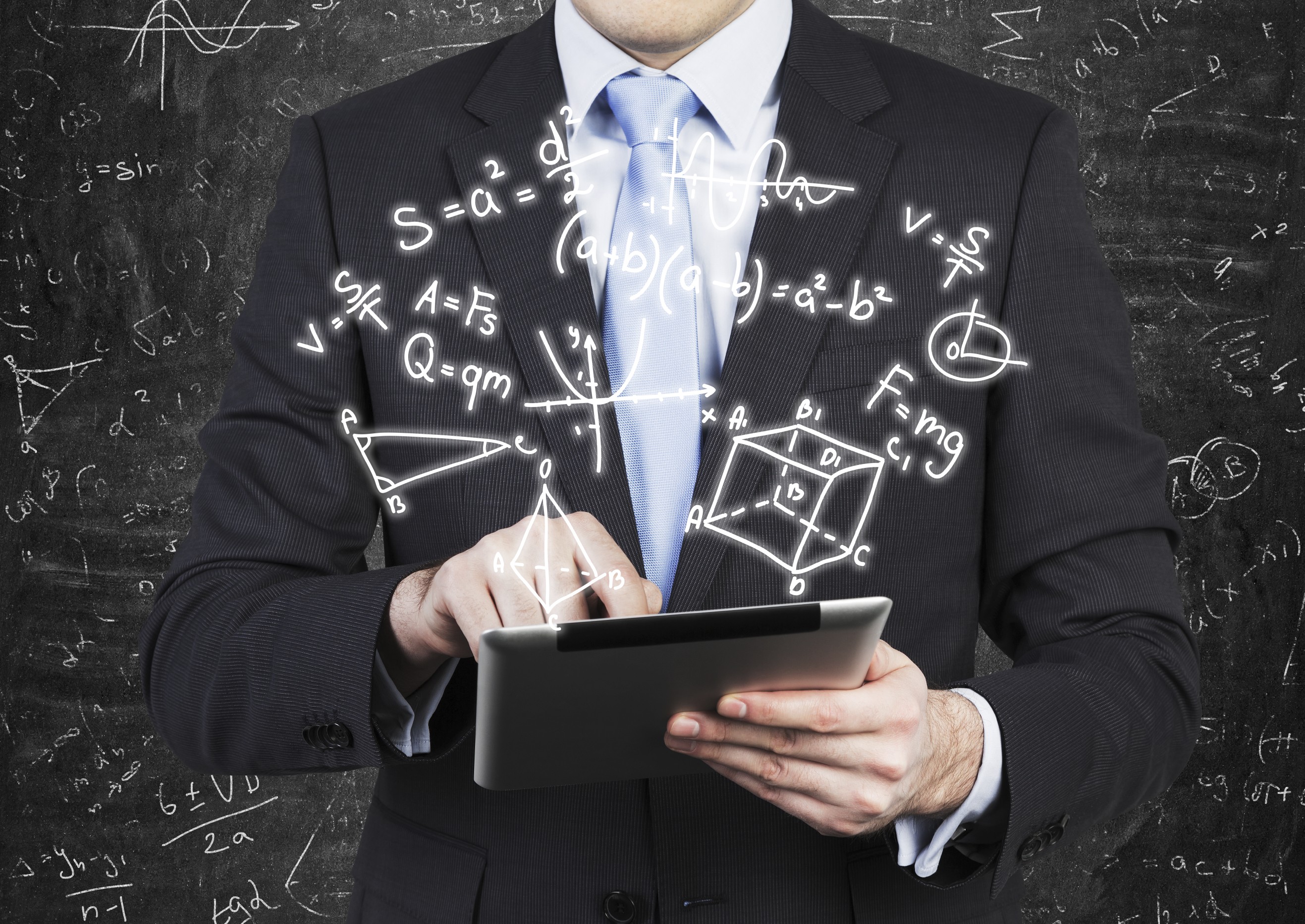 Young man in formal suit is holding a tablet with math formulas ...